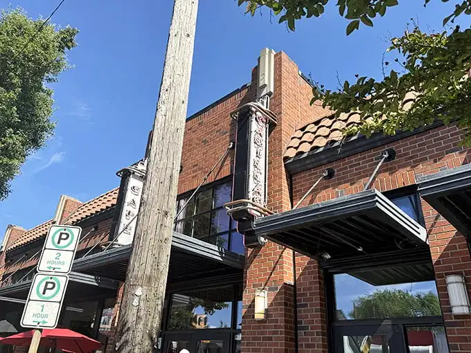The brick façade of Cadillac Café stands as Portland's breakfast beacon, promising culinary delights behind its unassuming exterior.