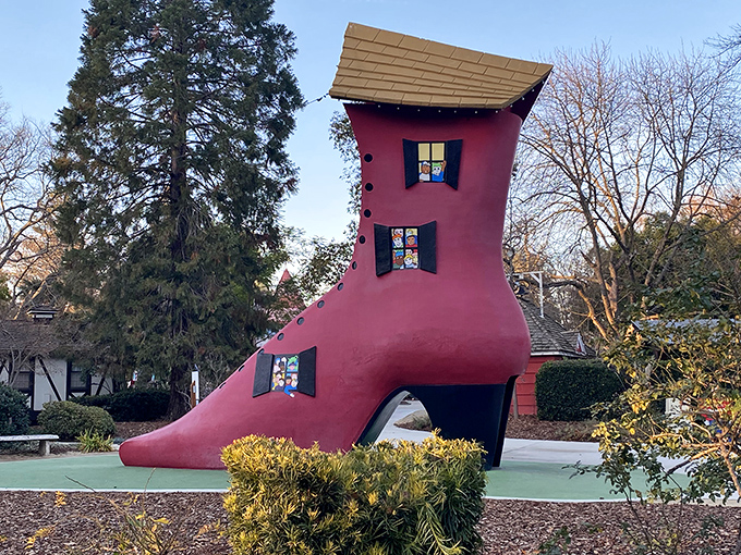 The Old Woman's Shoe stands tall in vibrant pink glory. Who knew footwear could double as real estate in this whimsical Sacramento wonderland?