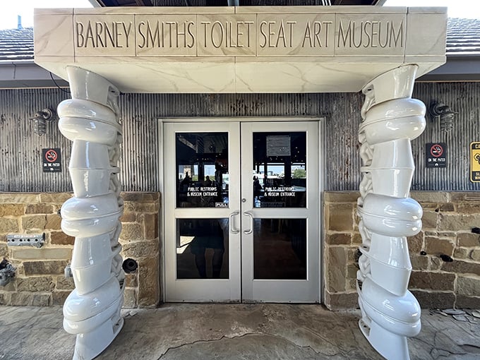 The entrance to Barney Smith's Toilet Seat Art Museum welcomes you with columns made of—what else?—stacked toilet seats!
