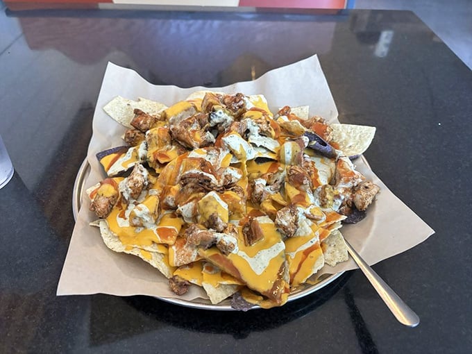BBQ nachos—where Tex meets Mex meets NC. A glorious mountain of chips, cheese, and chopped meat that makes sharing both necessary and slightly heartbreaking.