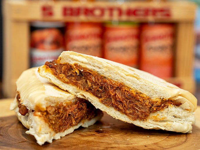 The pulled pork sandwich – where slow-cooked meat meets Cuban bread in a romance that puts Hollywood to shame.