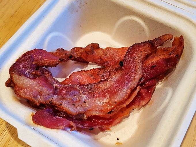 Bacon cooked to that perfect point between chewy and crisp—the Goldilocks zone that makes you wonder if you should order a second plate.
