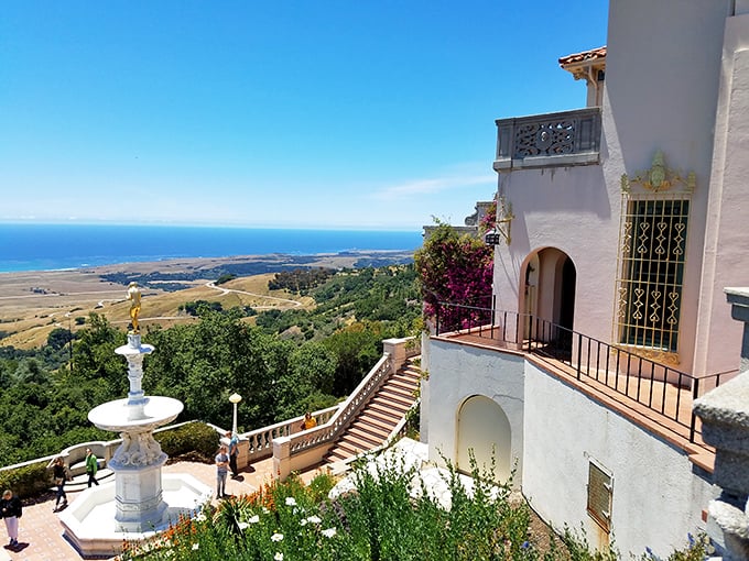 That view! The Pacific Ocean stretches to infinity below white terraces and bougainvillea – California coastal living at its most extravagant.