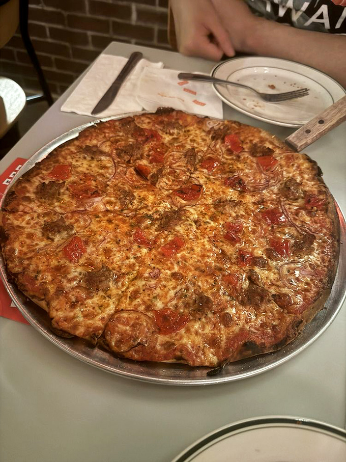 This isn't just pizza—it's architecture with cheese, where every crispy corner piece is worth fighting your best friend for.