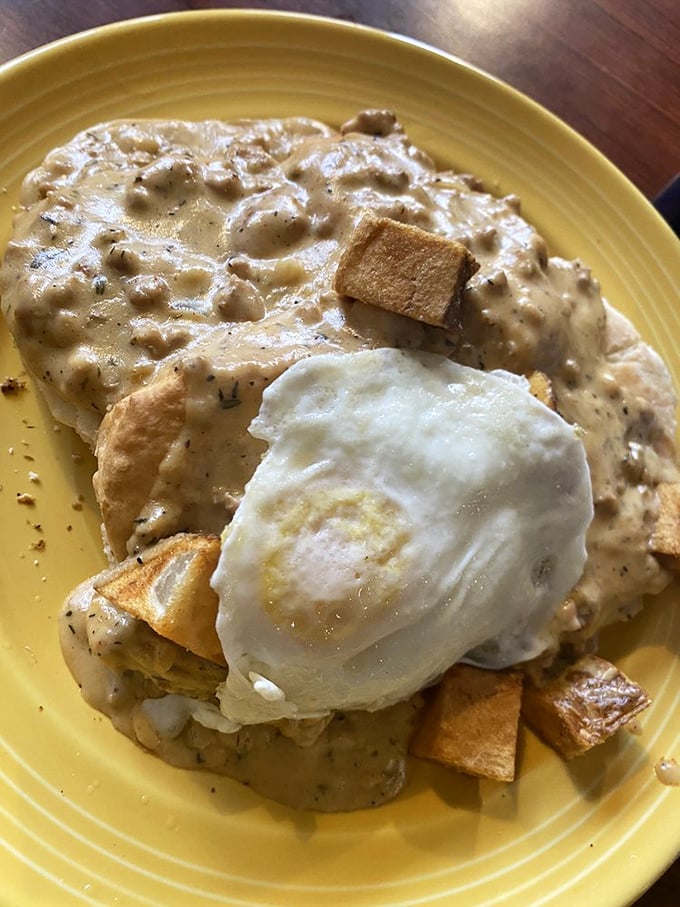 Biscuits and gravy with a sunny-side-up egg – the breakfast equivalent of a warm hug from your favorite grandma. Pure comfort in yellow ceramic.