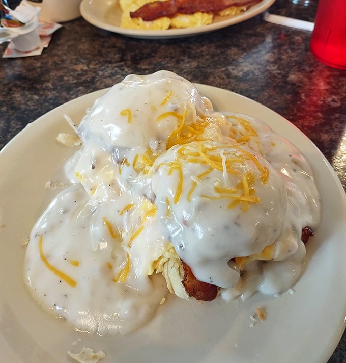 Biscuits buried under an avalanche of peppery gravy and melted cheese – the breakfast equivalent of being wrapped in a warm hug.