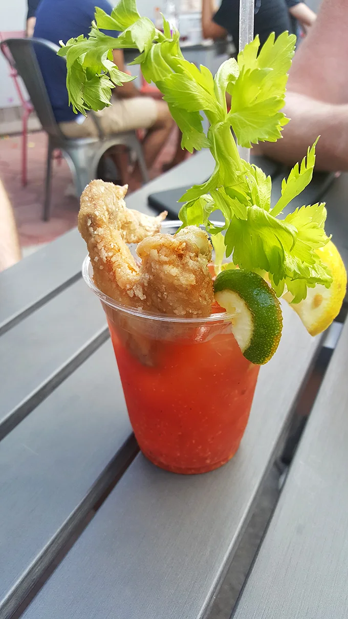 The Bloody Mary comes with its own chicken garnish—because why should celery have all the fun in cocktail accessories?