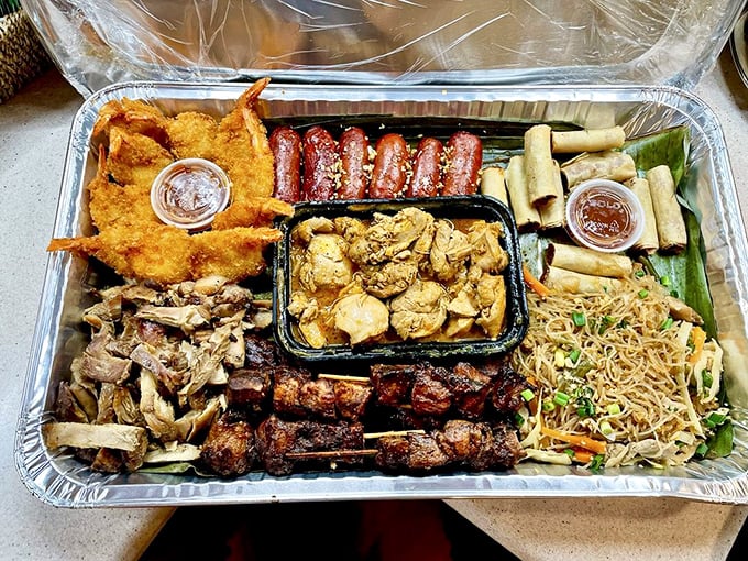 Behold the boodle platter—a feast fit for royalty. This aluminum tray contains more culinary diplomacy than the United Nations dining hall.