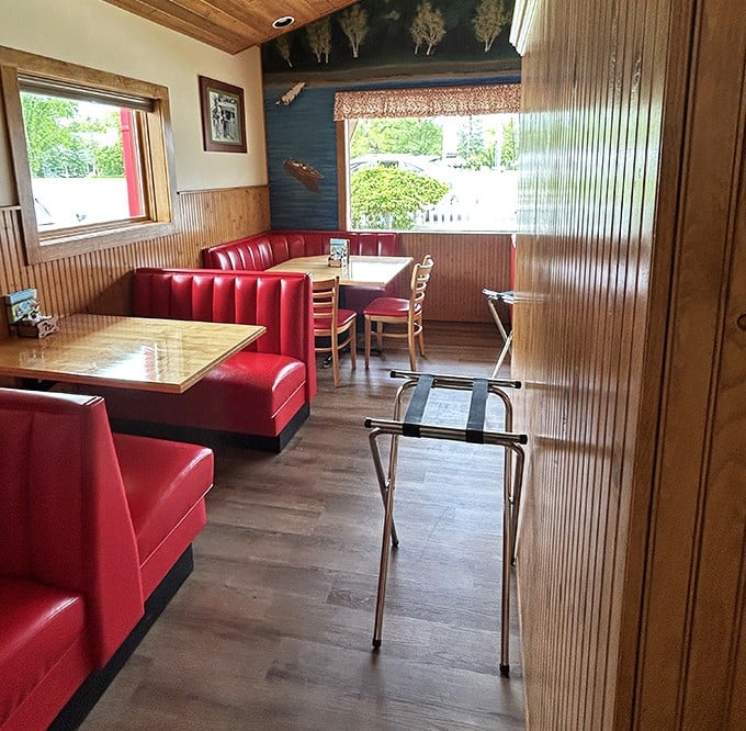 Those red vinyl booths aren't just seating—they're front-row tickets to the best show in town: your own happy food dance.