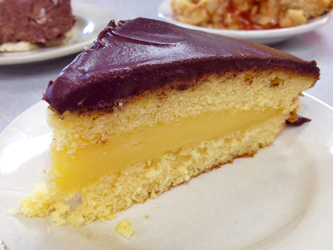 Boston cream pie that bridges the gap between cake and custard with diplomatic chocolate frosting. A dessert that demands to be savored.