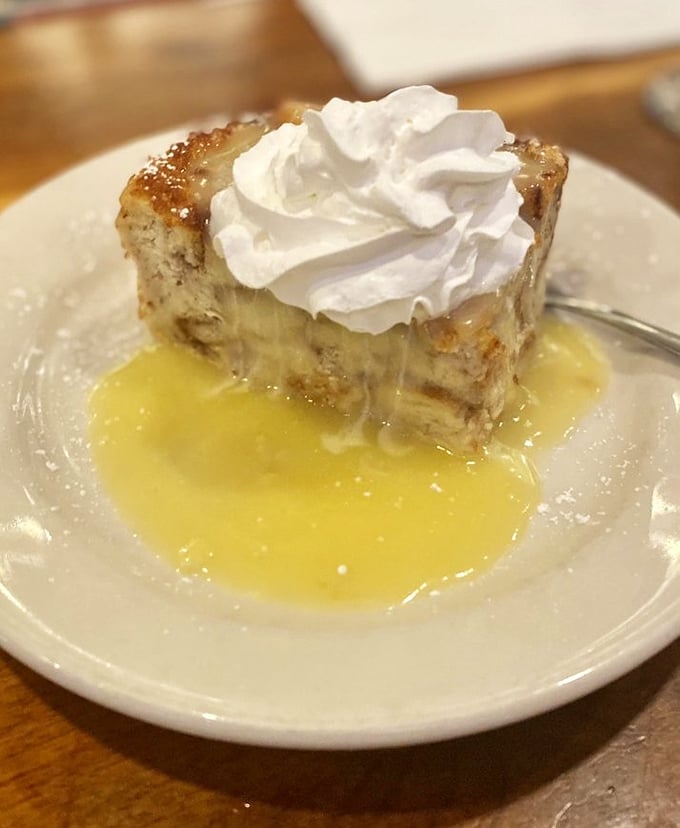 Bread pudding swimming in a custard sea with a whipped cream island. Desserts like this are why elastic waistbands were invented.