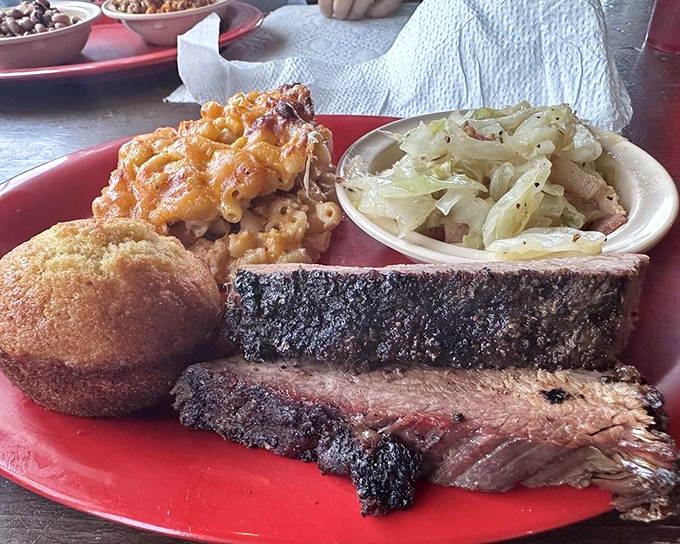 Brisket with the perfect bark, mac and cheese with the golden crust, and sides that refuse to be overshadowed—a plate of pure happiness.