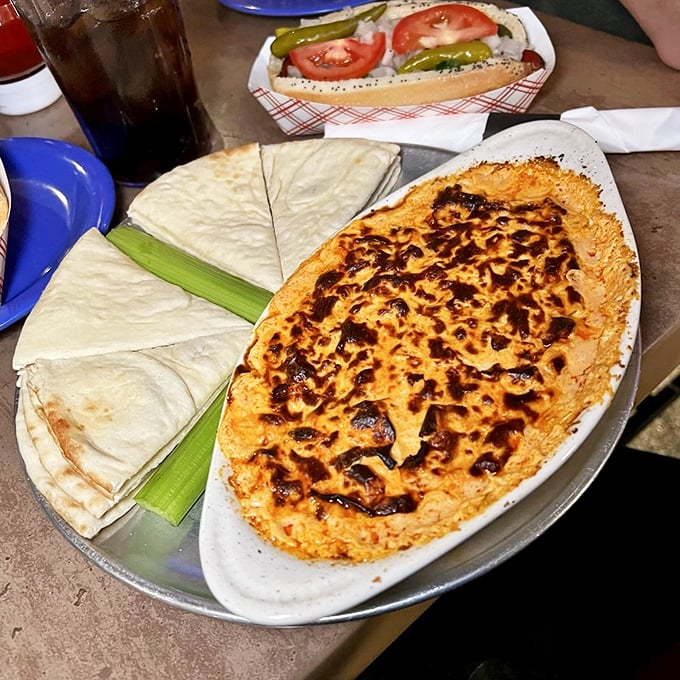 Buffalo chicken dip with warm pita triangles—the kind of appetizer that makes you consider canceling your entrée and ordering three more of these.