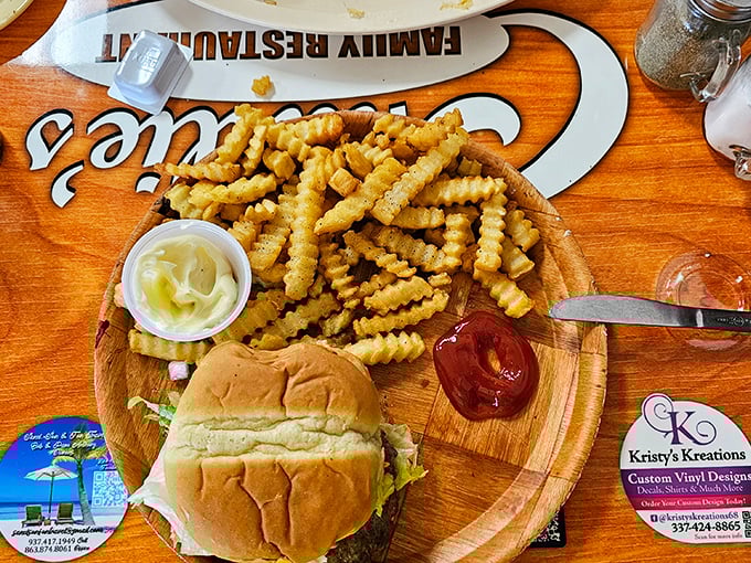 A burger and fries served on a wooden board—no pretentious slate plates here, just honest food that demands to be devoured.