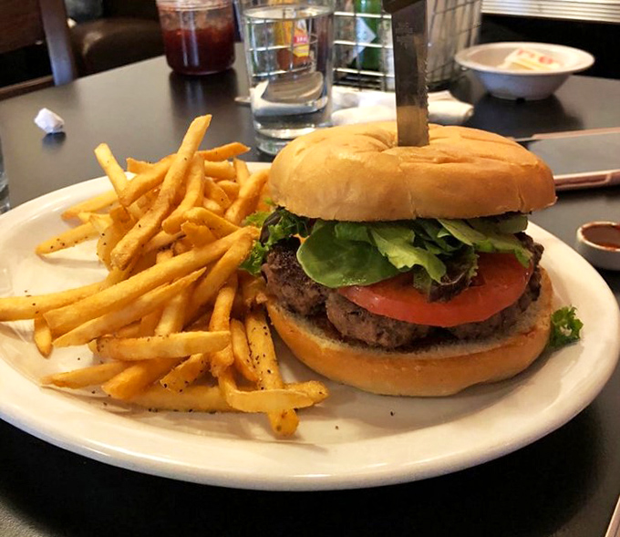 A burger that makes you question why you ordered breakfast. Those fries aren't just sides—they're golden ambassadors of potato perfection.