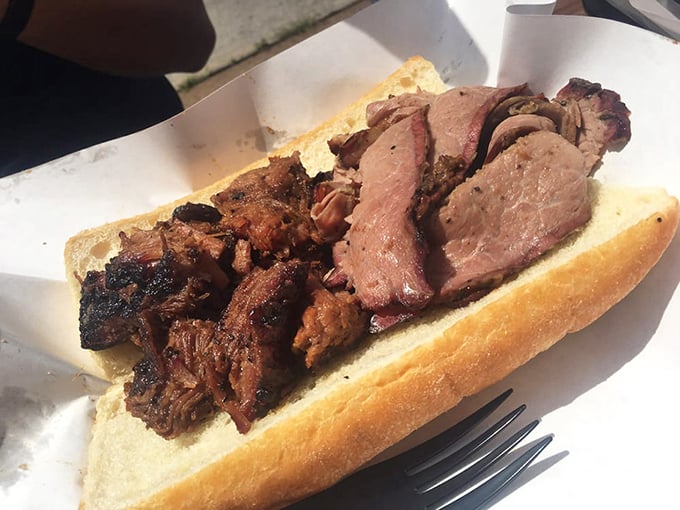 The holy trinity of BBQ: burnt ends and brisket on a sandwich with beans. Not all heroes wear capes—some come on paper plates.