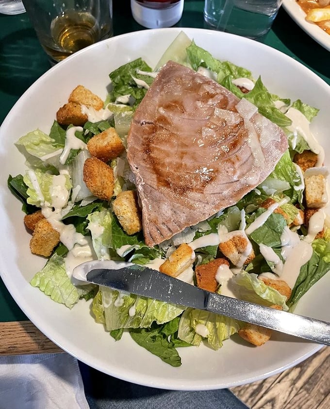 A Caesar salad elevated from supporting character to star with the addition of perfectly seared ahi tuna—proof that bar food can absolutely be sophisticated.