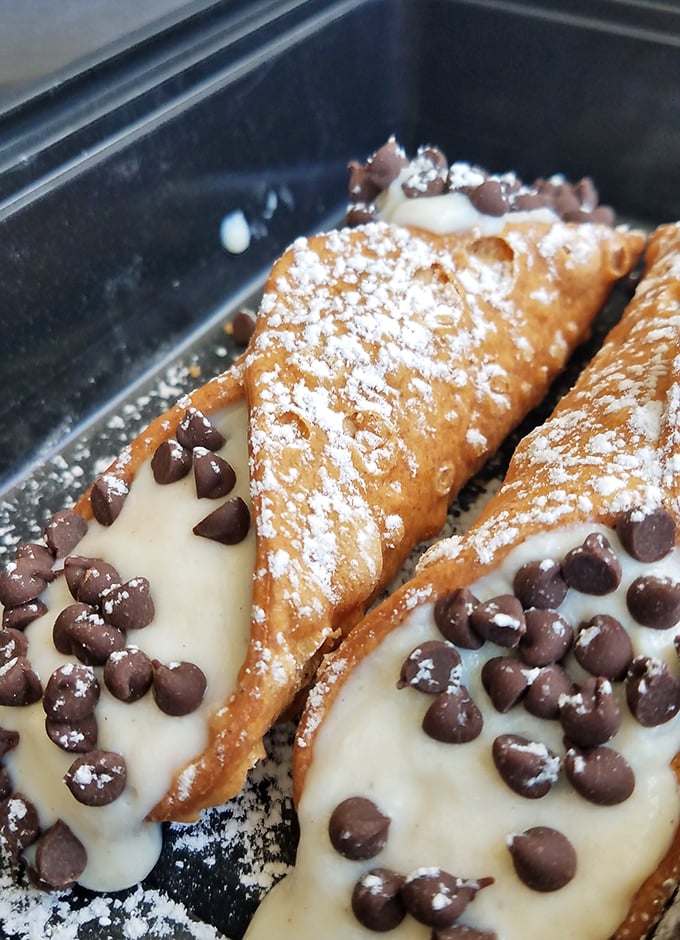 These cannoli aren't just desserts—they're little armor-plated vessels of sweetened ricotta topped with chocolate chips that justify any detour.