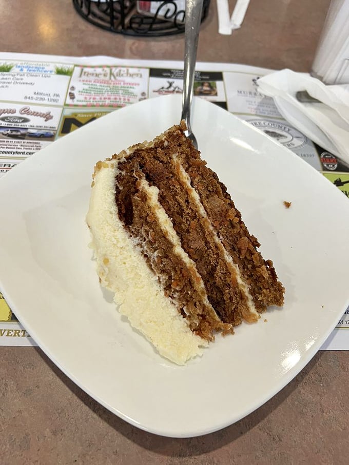 Three layers of carrot cake with cream cheese frosting thick enough to leave evidence on your fork. Worth every calorie-counting app notification.