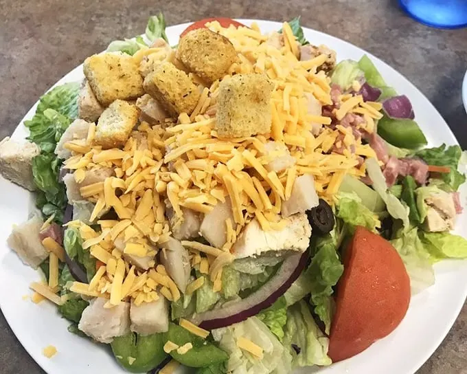 A chef salad that actually looks like someone who cooks for a living made it – generous, colorful, and not apologizing for that glorious cheese.