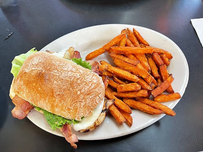 This chicken sandwich with sweet potato fries isn't trying to be trendy—it's just confidently, deliciously classic, like everything else at Fitz's.