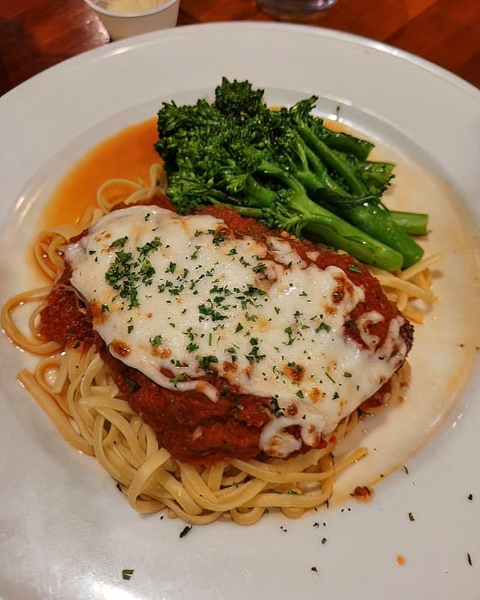 This chicken parmesan isn't just dinner—it's a warm Italian hug on a bed of perfectly twirled pasta.