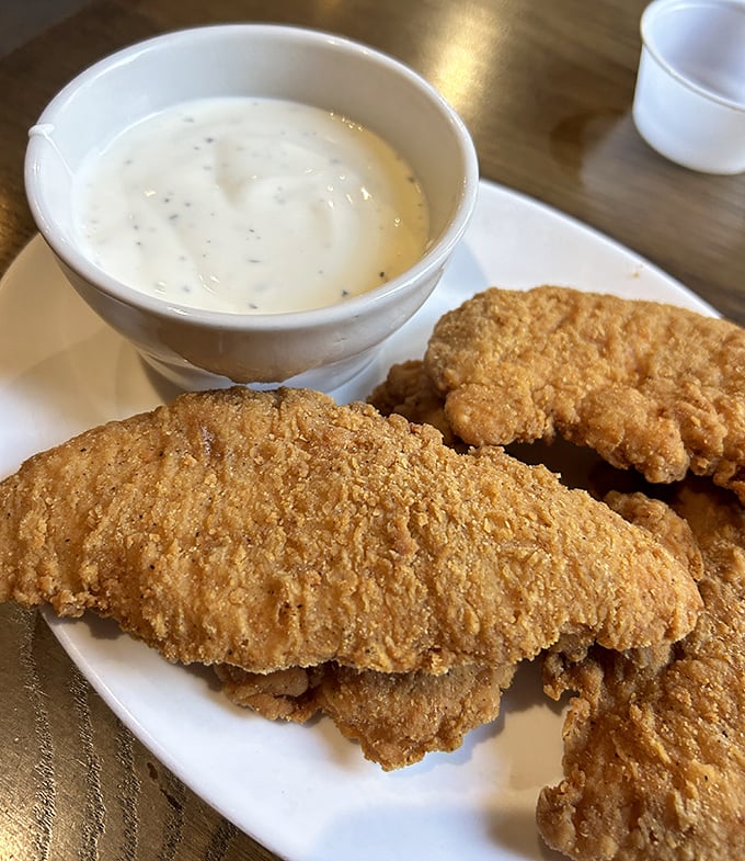 Chicken tenders that actually deserve the name "tender," with a golden crust that crackles with each bite. Dipping sauce not optional!