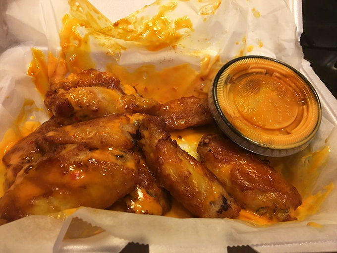 These wings aren't playing second fiddle to pizza—they're headlining their own show with a sauce that demands to be licked from fingers without shame.