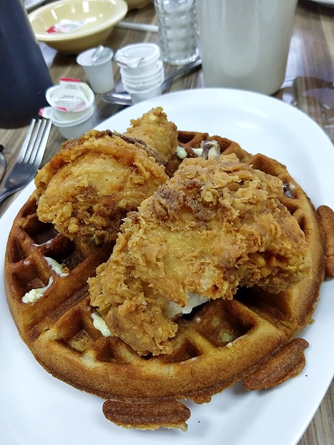 Southern ingenuity at its finest—golden-brown chicken perched atop a waffle throne, waiting for that magical moment when maple syrup ties everything together.