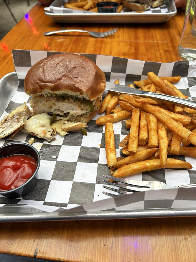 A sandwich that requires both hands and your full attention. That golden-brown bun and perfectly crisp fries are the lunch of champions.