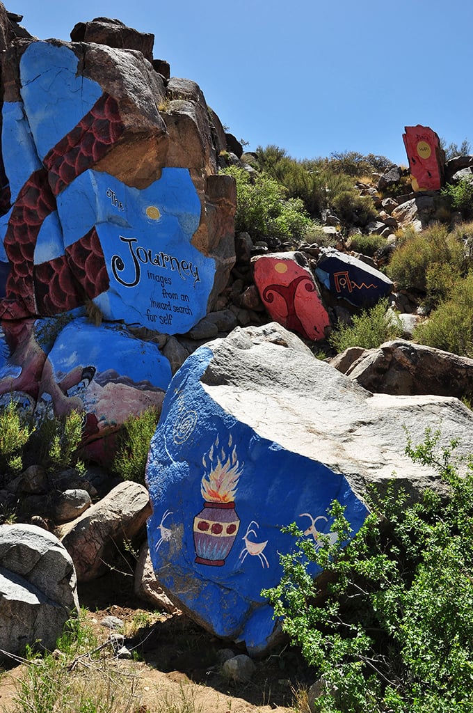 Roy Purcell's vibrant murals transform desert boulders into a psychedelic journey – an unexpected splash of color hidden in the monochrome landscape of the Cerbat foothills.
