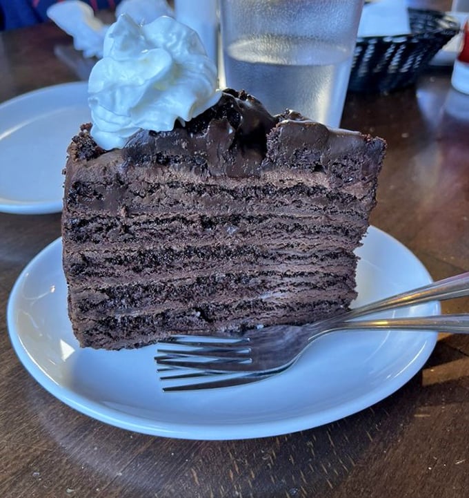 A slice of chocolate cake so rich it should come with its own tax bracket. The perfect sweet finale after a seafood marathon—because balance is important in life.