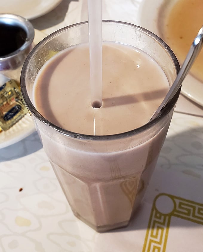 Chocolate milk in a classic diner glass – proof that some childhood pleasures actually get better when you're old enough to order them yourself.