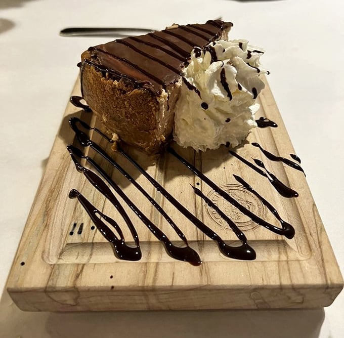 Dessert architecture at its finest—chocolate mousse cake presented like edible art. That whipped cream and chocolate drizzle are the accessories this runway model deserves.