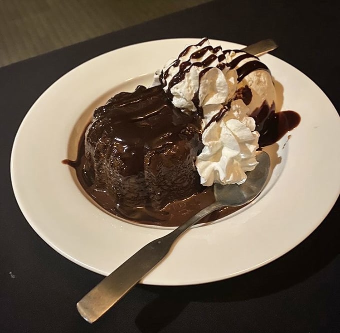 The chocolate volcano cake erupts with warm fudge and cool cream—a sweet finale that somehow finds room even after a hearty steak dinner.