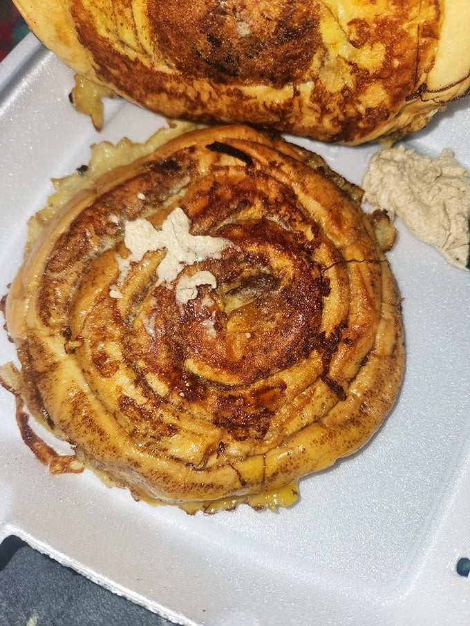 This cinnamon roll doesn't spiral—it hypnotizes, beckoning you toward cinnamon-scented bliss with its perfect caramelized swirls.