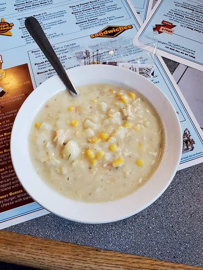 A bowl of clam chowder that whispers "New England" but speaks with a distinct Delaware accent—creamy, comforting, and studded with sweet corn.