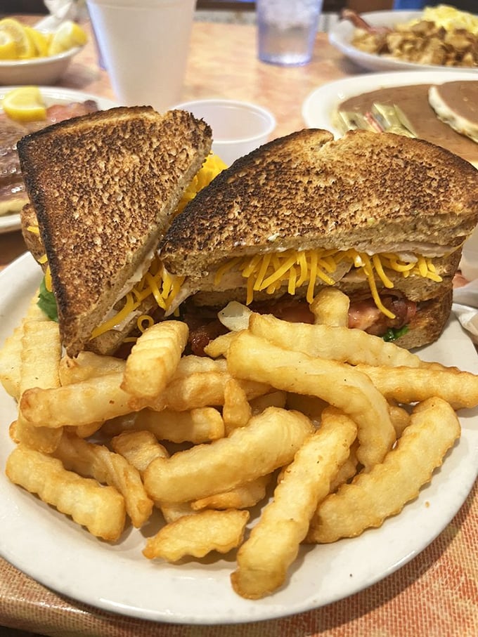 A proper club sandwich with crinkle-cut fries – the lunch equivalent of a warm hug from your favorite aunt.