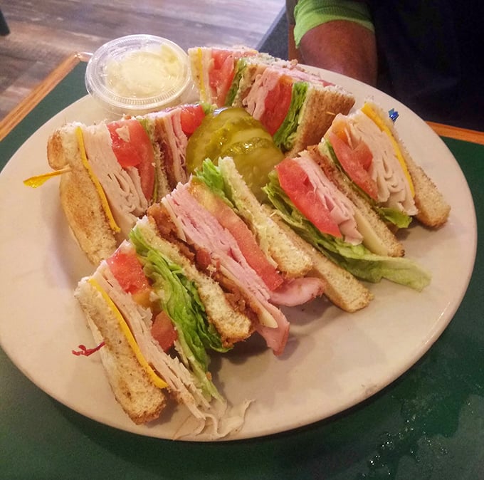 This club sandwich stands tall and proud, layers stacked with military precision and enough fillings to require a strategic eating plan.
