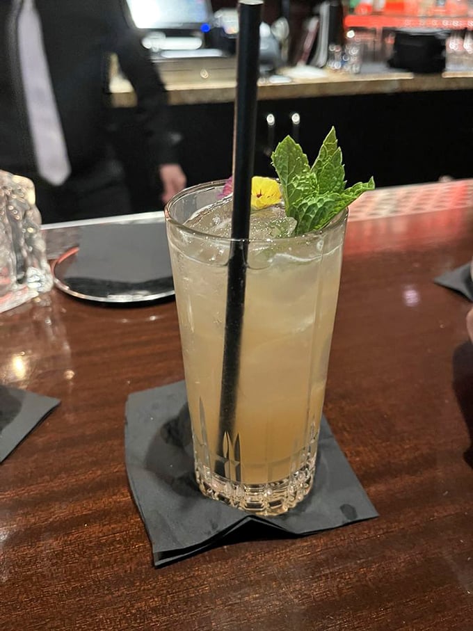 A refreshing cocktail garnished with fresh mint and citrus—the kind of drink that makes you feel sophisticated even if you're still wearing yesterday's socks.