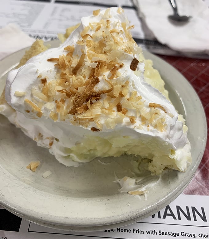 Coconut cream pie with a meringue so high it needs FAA clearance. This isn't dessert—it's a fluffy cloud of happiness on a plate.