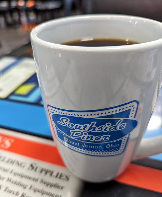 That iconic mug says it all—this isn't just coffee, it's liquid motivation served with unlimited refills of small-town charm.