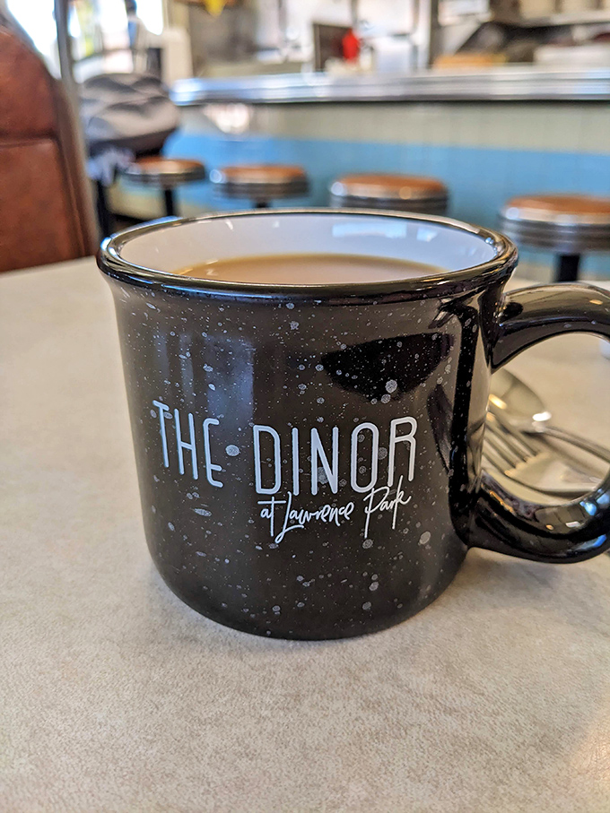 That speckled mug isn't just holding coffee—it's cradling liquid motivation, locally roasted and served with a side of diner philosophy.