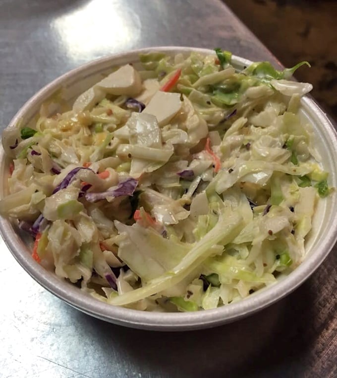 Coleslaw that knows its job: crisp, tangy, and ready to rescue your burning tongue.