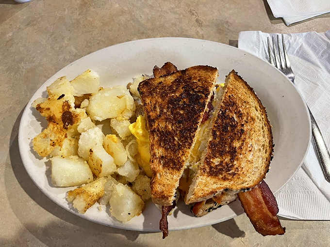 This grilled cheese isn't playing games—it's bringing reinforcements of perfectly golden bread and home fries that refuse to be upstaged.