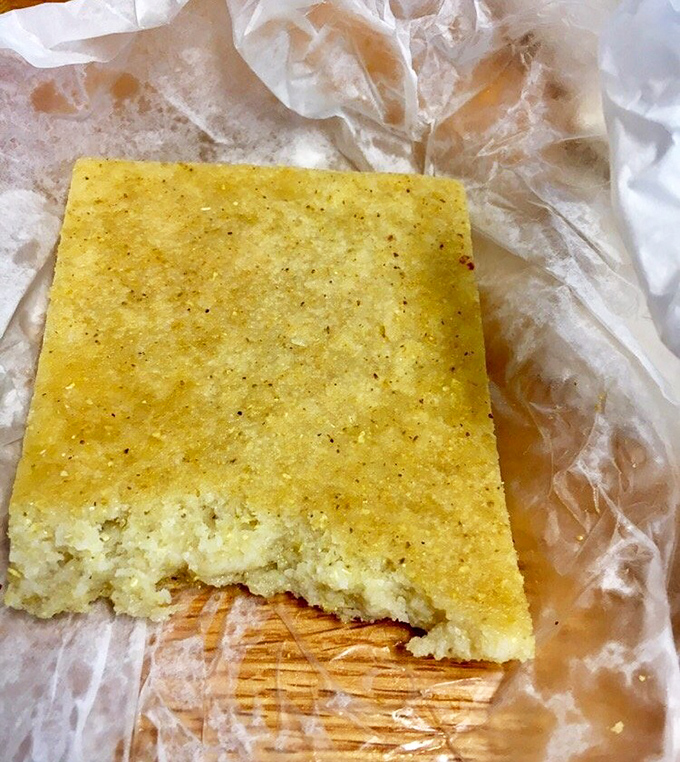 This isn't just cornbread—it's an edible sponge designed by barbecue scientists to capture every last drop of that vinegar sauce.
