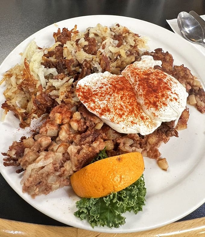 Corned beef hash supporting two perfectly poached eggs—a breakfast power couple that proves sometimes the classics deserve their legendary status.