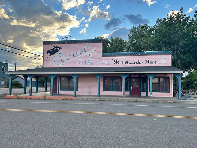 The Corner Club Cafe's pink facade isn't just a building—it's an invitation to sit down, stay awhile, and remember when conversations didn't require Wi-Fi.