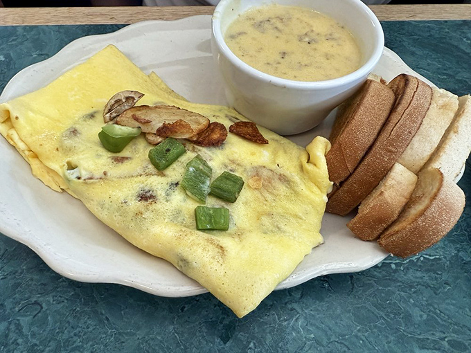 This isn't just an omelet; it's a morning masterpiece where farm-fresh eggs meet perfectly sautéed mushrooms in a dance of breakfast perfection.