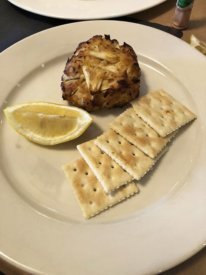 The quintessential Maryland crab cake – a golden-brown monument to minimalism where crab is the star and fillers know their place.